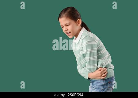 Teenage girl with appendicitis on green background Stock Photo - Alamy