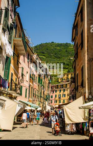 via roma street in genoa,italy,decorated with colorful umbrellas on top ...