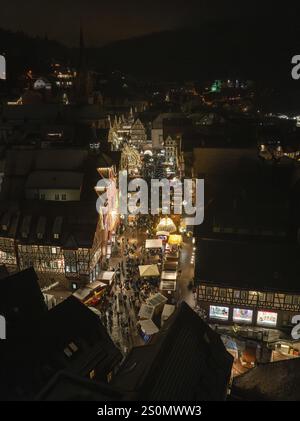 Aerial view of a lively Christmas market with many lights and visitors ...