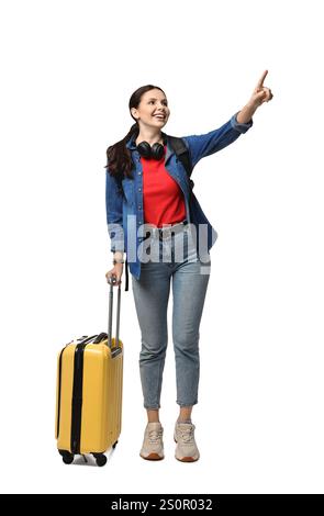Young tourist with suitcase pointing at something on white background ...