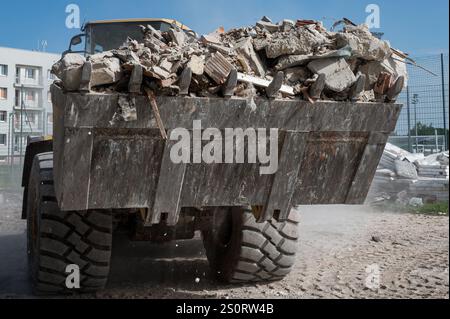 The loader is carrying rubble from the demolition of a building Stock ...