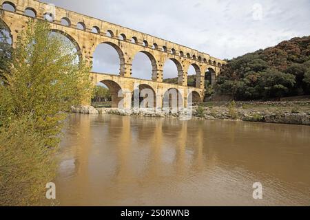 Visitors admire the impressive Roman aqueduct bridge in a scenic ...