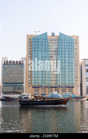Abra boat a a cargo ship with the Emirates NBD headquarters building in ...