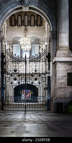 Decorative wrought-iron gates flanked by red brick pillars as frontage ...