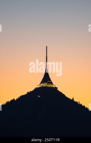 Illuminated against the twilight, Jested Tower towers over Liberec ...