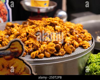 Delicious grilled baby octopus skewer street food stall with appetizing ...