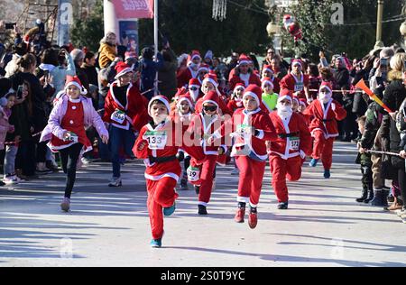 Participants dressed as Santa Clauses run during the traditional Santa ...