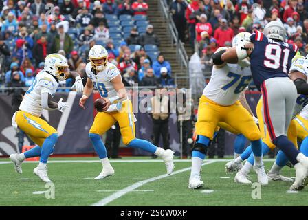 Los Angeles Chargers quarterback Justin Herbert, left, hands the ball ...