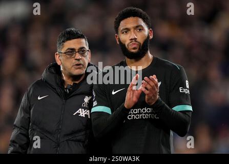 Liverpool's Joe Gomez (right) leaves the field after sustaining an ...