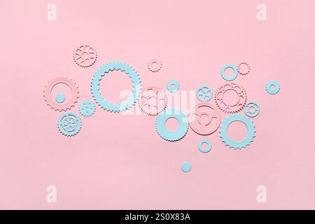 Different paper gears on pink background Stock Photo - Alamy