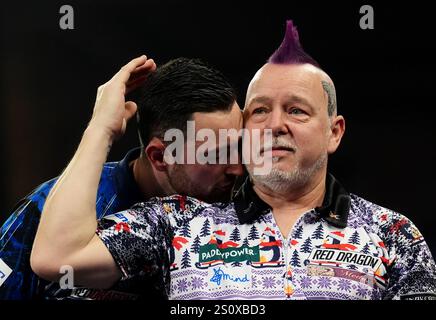 Peter Wright reacts after winning his fourth round match against Luke ...