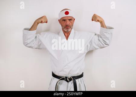 Karate master showing his arm muscles Stock Photo - Alamy