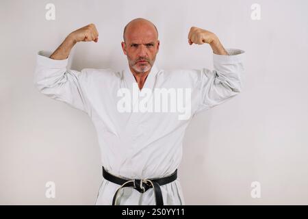 Karate master showing his arm muscles Stock Photo - Alamy