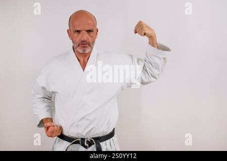 Karate master showing his arm muscles Stock Photo - Alamy
