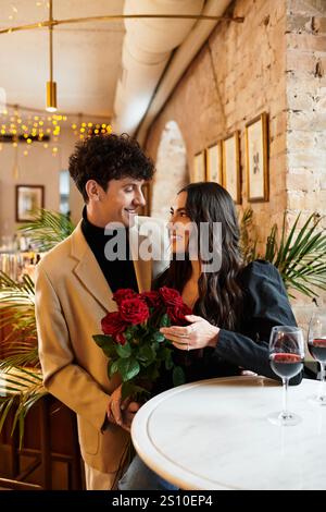 Young couple in love with roses and balloons on black background ...