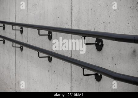 Fragment of a gray concrete wall with metal structures Stock Photo - Alamy