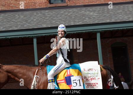 Rodeo Parade Scene Featuring Woman Riding Decorated Horse in Town ...