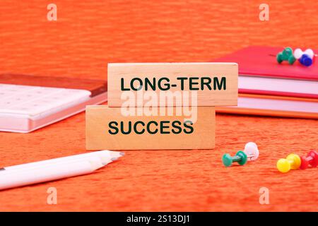 LONG-TERM, text on orange rectangle stamp sign Stock Photo - Alamy