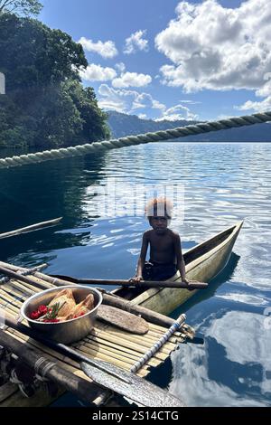 Residents of Vitu Islands in their traditional dugout canoes, Garove ...