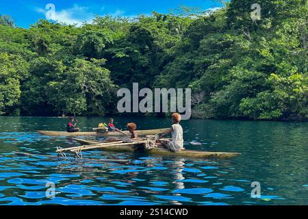 Residents of Vitu Islands in their traditional dugout canoes, Garove ...