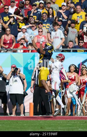 Michigan defensive back Aamir Hall (12) and Wesley Walker (13 ...