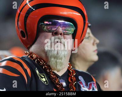A Denver Broncos fan watches during the first half of an NFL football ...
