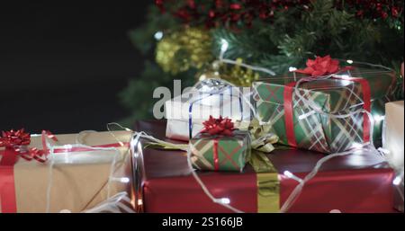 Wrapped gifts sit under a festive Christmas tree, with copy space Stock ...