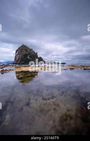 A dramatic coastal scene of Diguisit, Aurora featuring two rugged rock ...