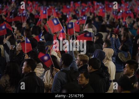 Residents hold Taiwan flags as they attend a flag-raising ceremony in ...