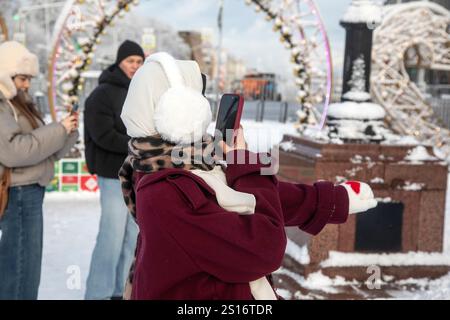 People take pictures with a decorations New Year on display at shopping ...