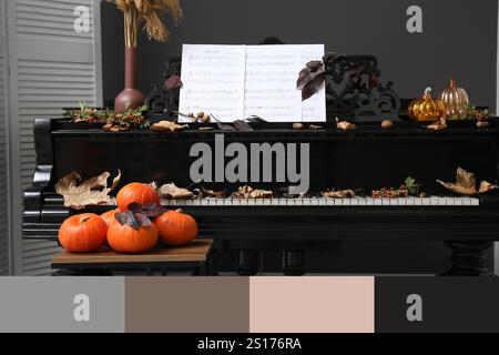 Autumn leaves, pumpkins and note sheets on grand piano. Different color ...