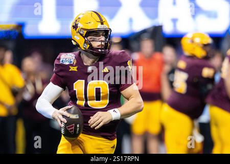 Arizona State quarterback Sam Leavitt (10) leaps over Texas Tech ...