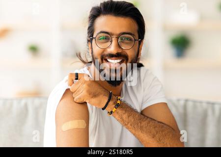 Happy man showing arm with band on and thumb up Stock Photo - Alamy