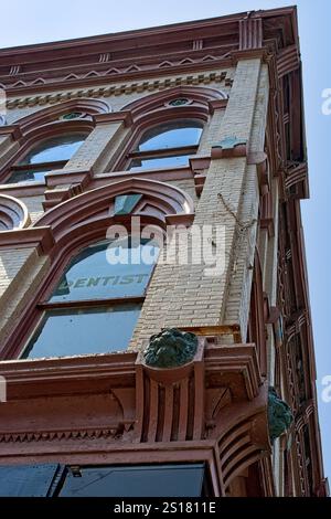 Ornate detail window pediments and brick work on facade of 1888 brick ...