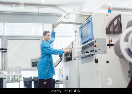 Woman worker at visual inspection of PCB on electronics assembly line ...