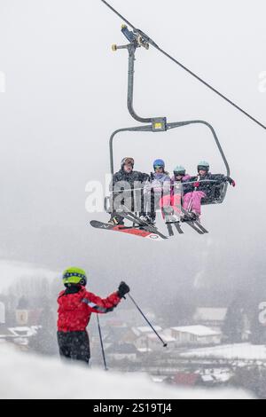 Skiers, snowboaders enjoy skiing in ski areal in Destne in Orlicke ...