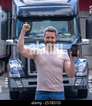 Happy Truck driver. CDL. Portrait of trucker standing by his truck ...