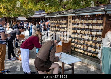Writing down wishes on the Ema (votive tablet) and hang it on the ...