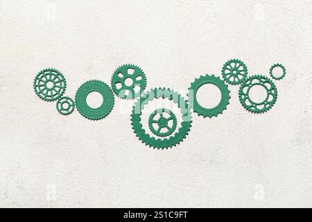 Green paper gears on white background Stock Photo - Alamy