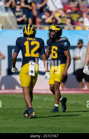 Michigan defensive back Aamir Hall (12) and Wesley Walker (13 ...