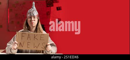 Female conspiracy theorist in protective foil cap and glasses debunks ...