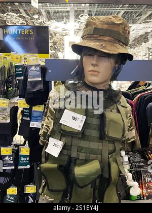 Mannequin dressed in camouflage attire and tactical gear on display in ...