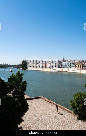 Guadalquiver river in summer view from the bridge, Sevilla Tower in the ...