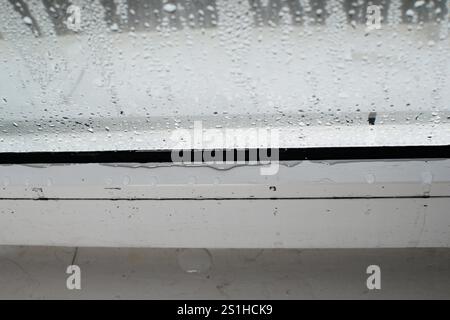 water flows on the glass. condensation drops on the window Stock Photo ...