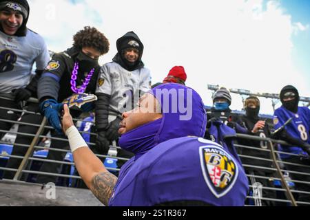 Baltimore Ravens running back Keaton Mitchell, bottom right, dives ...