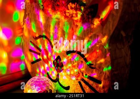 Cat Face Pinata Decoration Illuminated by Red Lights on Black ...