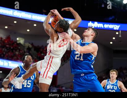 BYU guard Trevin Knell (21) dribbles the basketball guarded by Utah ...