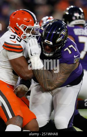 Baltimore Ravens guard Daniel Faalele (77) stands on the field after a ...