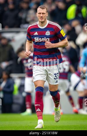 Dan Burn #33 of Newcastle United runs with the ball during the Premier ...