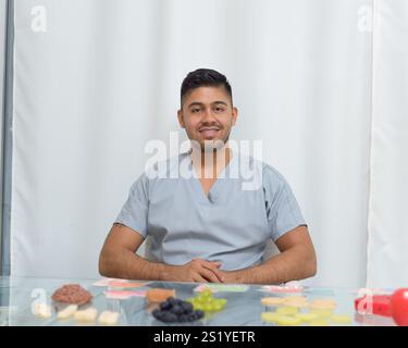 A nutritionist sitting in her office in front of a table with food ...